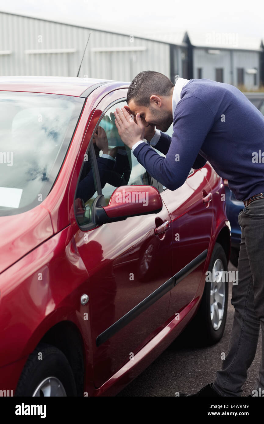 Man looking through the window of the car Stock Photo - Alamy