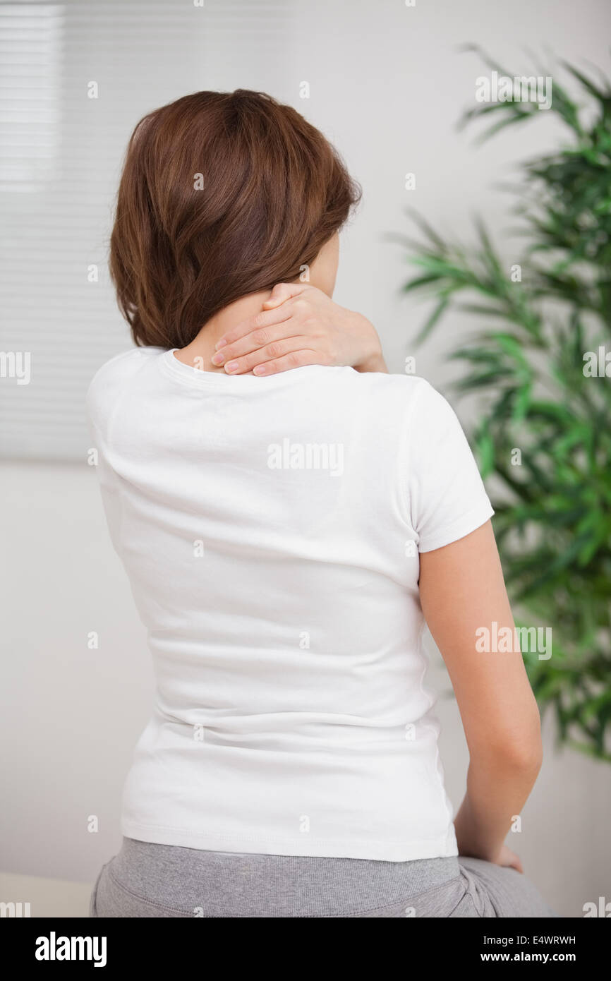 Woman touching her painful nape Stock Photo - Alamy