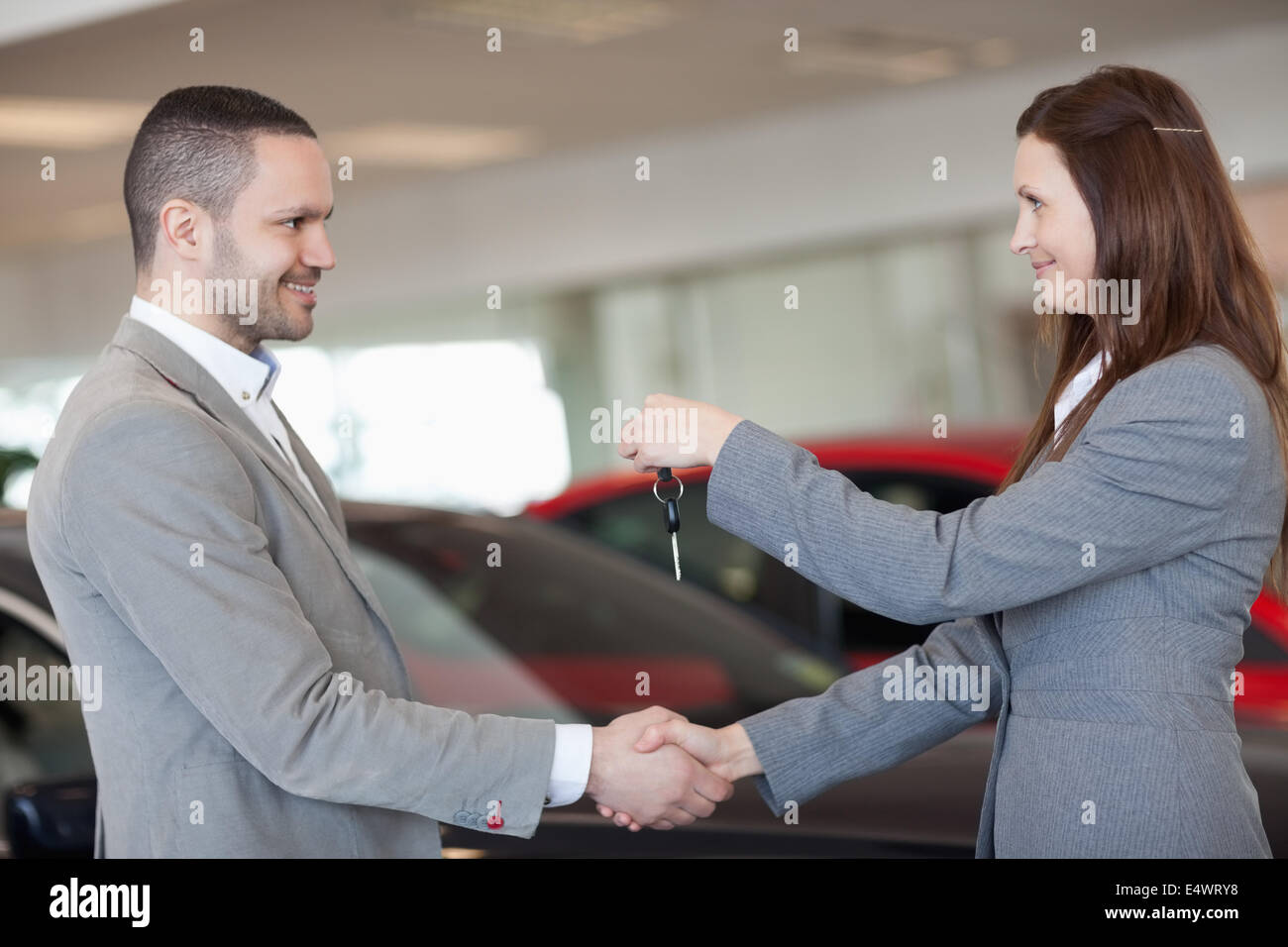 Man receiving car keys while shaking hand Stock Photo - Alamy