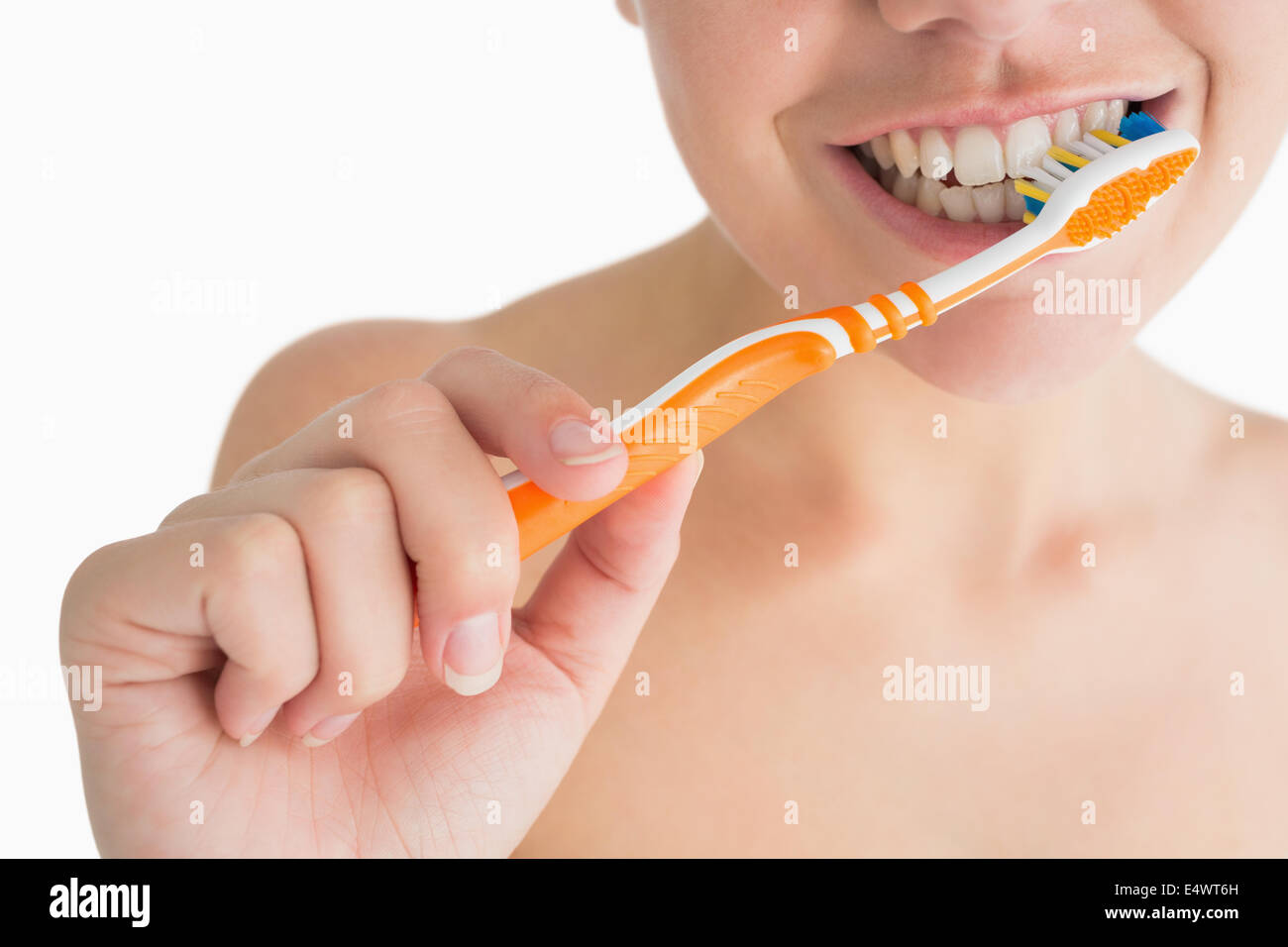 Smiling woman washing her teeth Stock Photo - Alamy