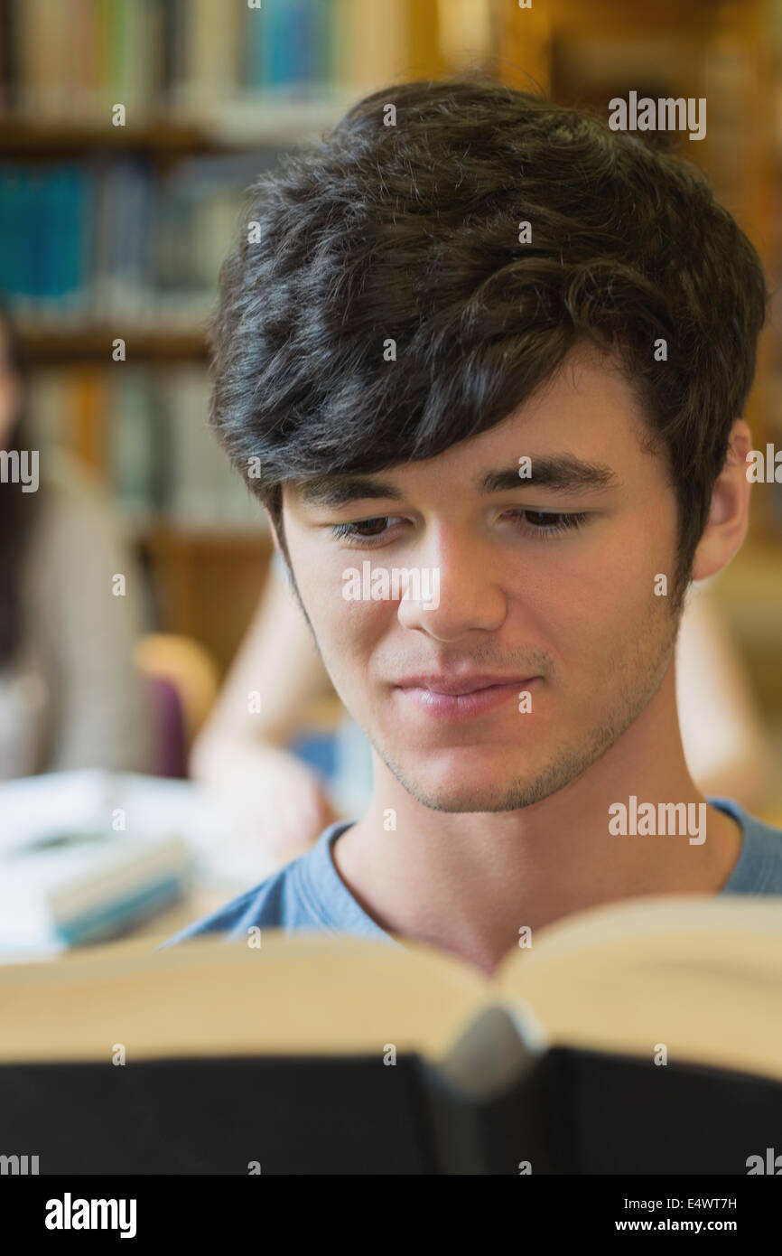 Student reading a book Stock Photo - Alamy