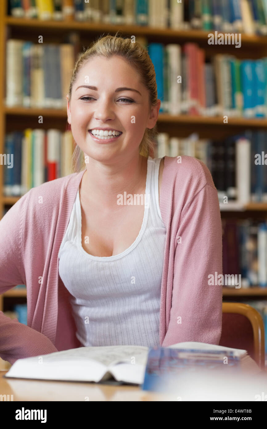 Student sitting at library desk Stock Photo - Alamy