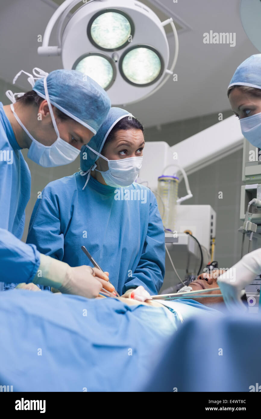 Serious doctors operating a surgical tools Stock Photo - Alamy