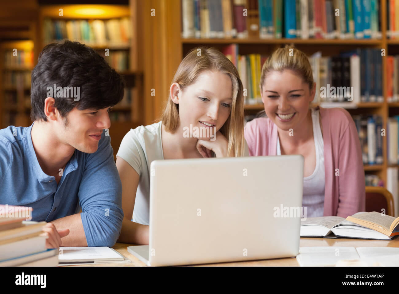 Students sitting at the library with laptop Stock Photo - Alamy