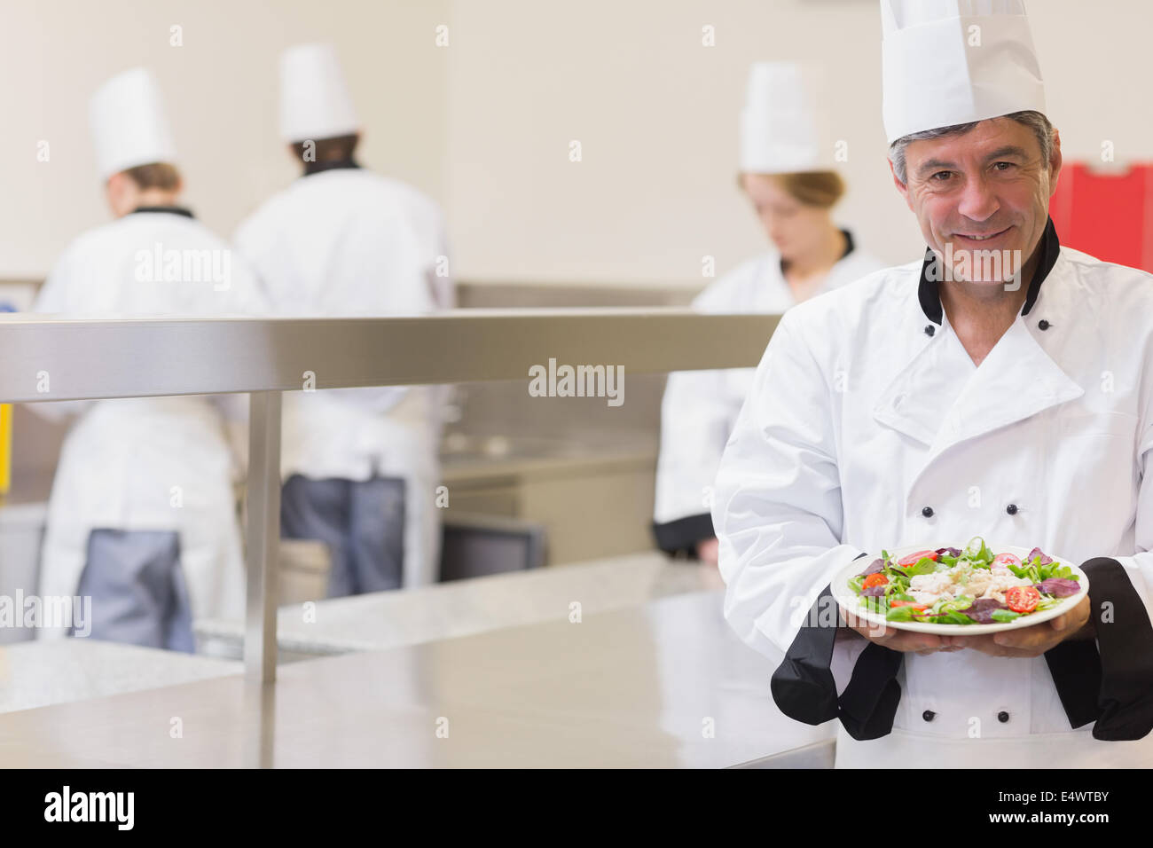Smiling chef presenting his salad Stock Photo - Alamy