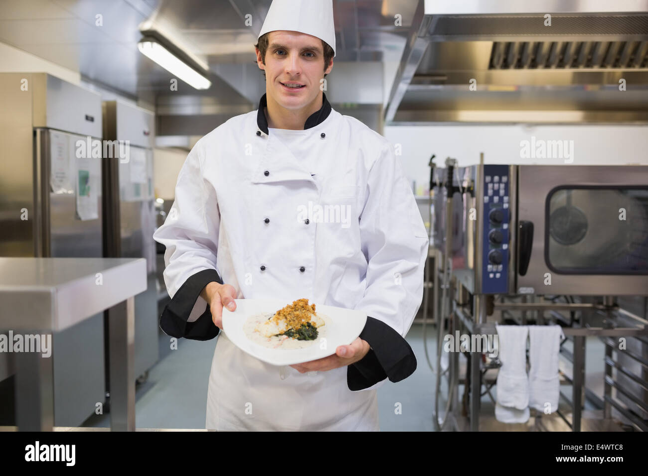 Cheerful chef presenting his plate Stock Photo - Alamy