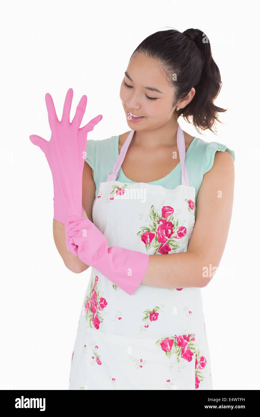 Woman pulling on rubber gloves Stock Photo - Alamy