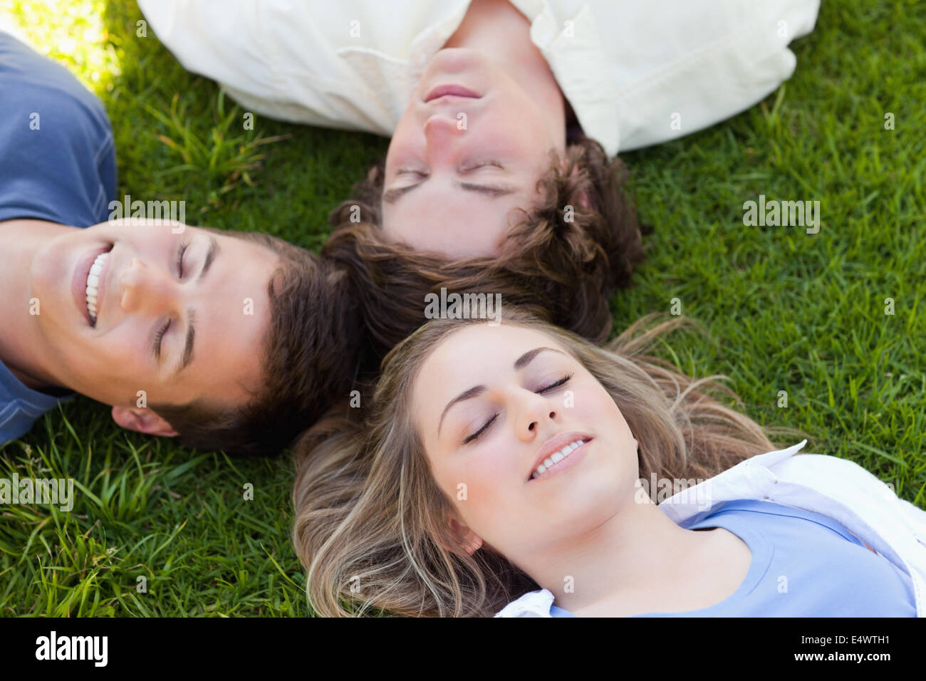 Three students resting together Stock Photo - Alamy