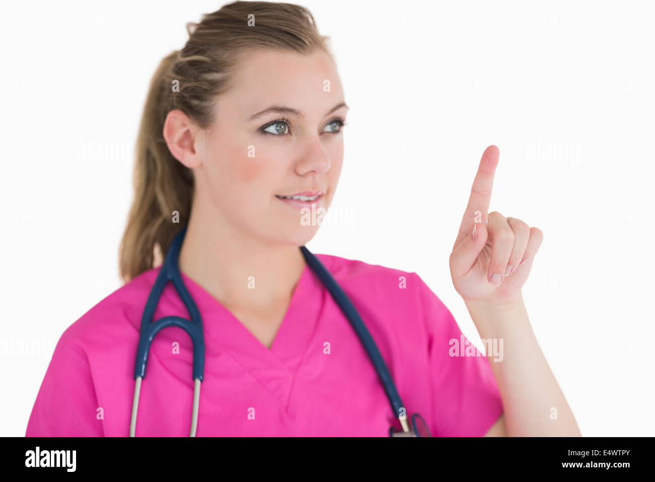 Smiling doctor pointing at something Stock Photo - Alamy