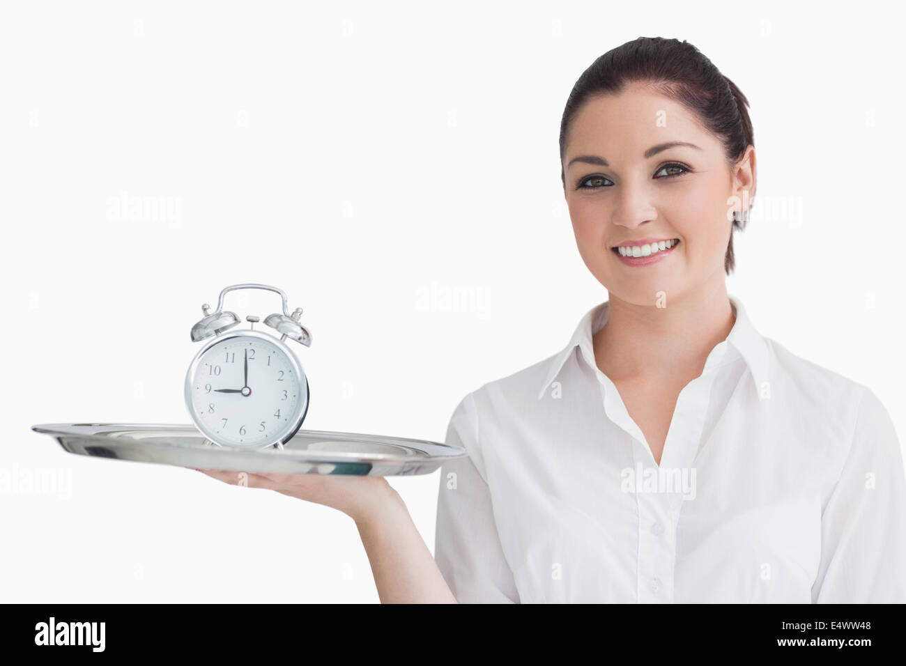 Waitress holding alarm clock on a tray Stock Photo - Alamy