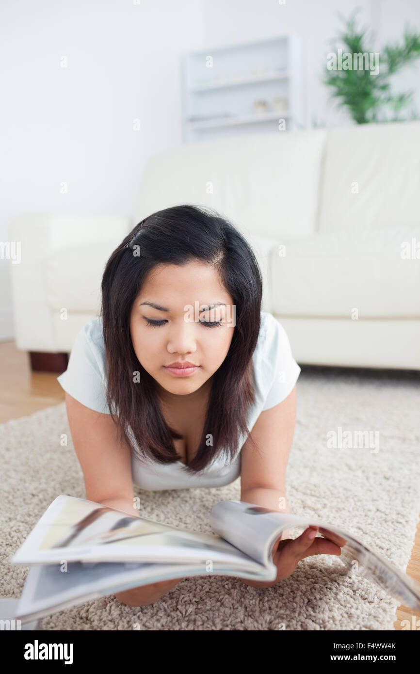 Woman reading a magazine on the floor Stock Photo - Alamy