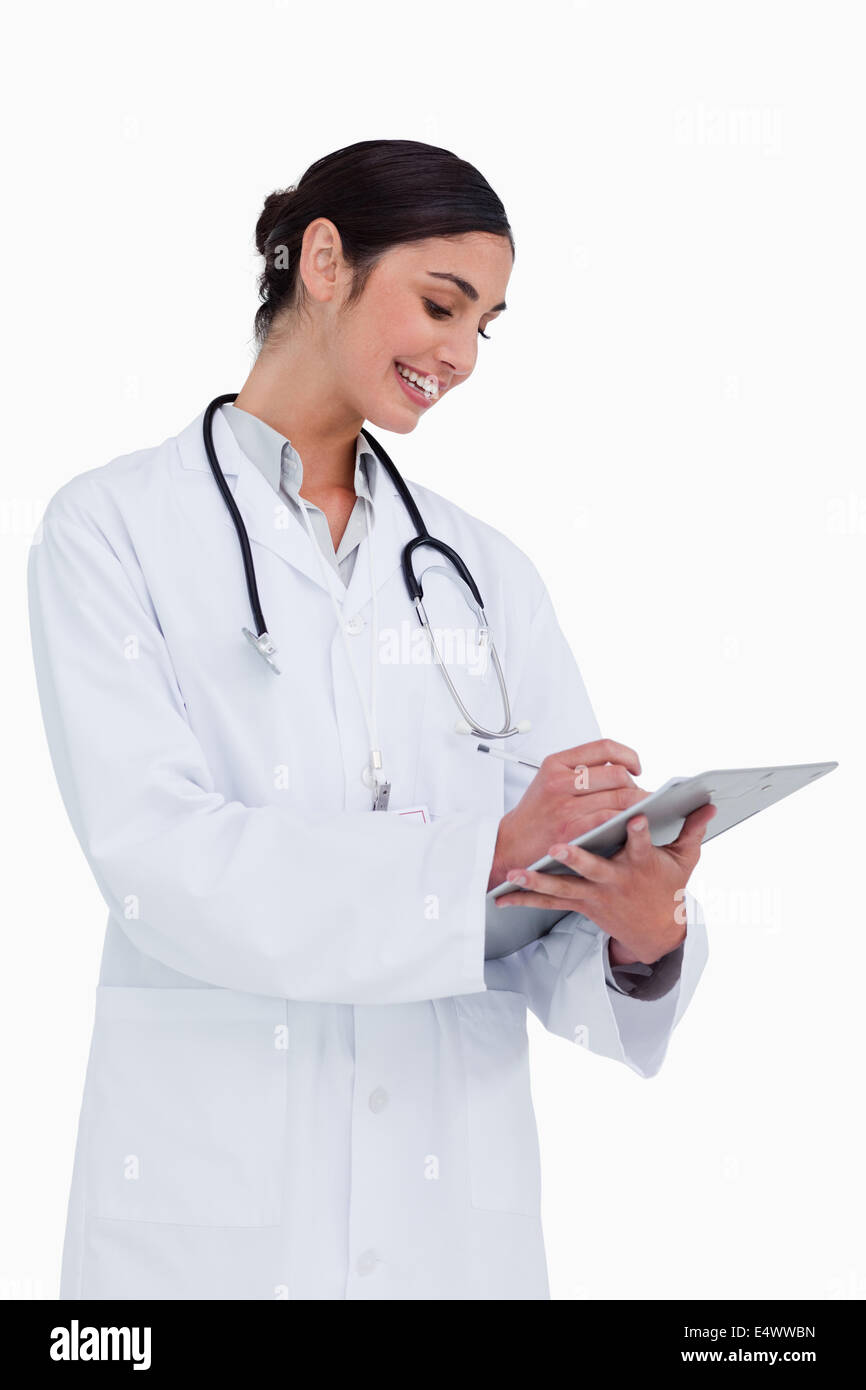 Side view of female doctor taking notes Stock Photo - Alamy