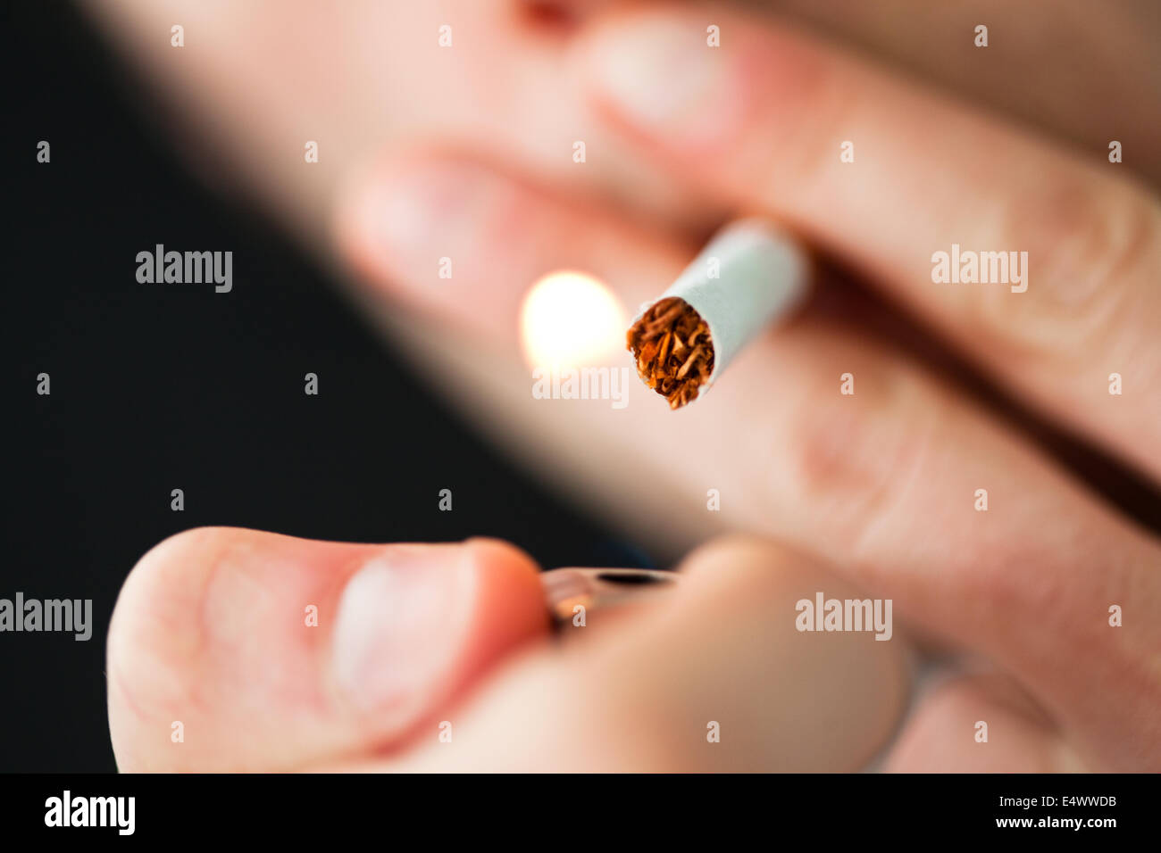 Close up of a man lighting a cigarette Stock Photo - Alamy