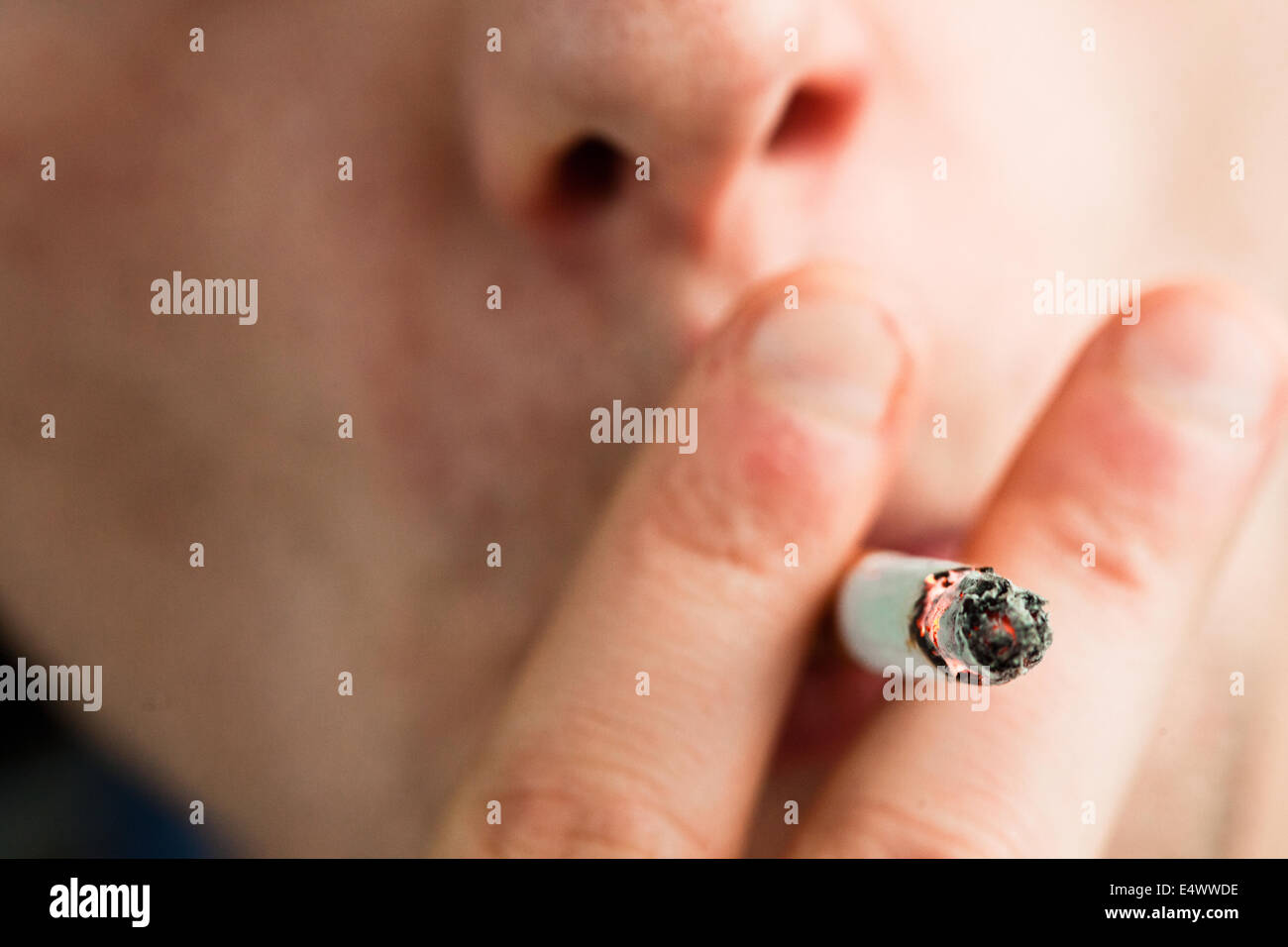Extreme close up man smoking cigarette hi-res stock photography and ...