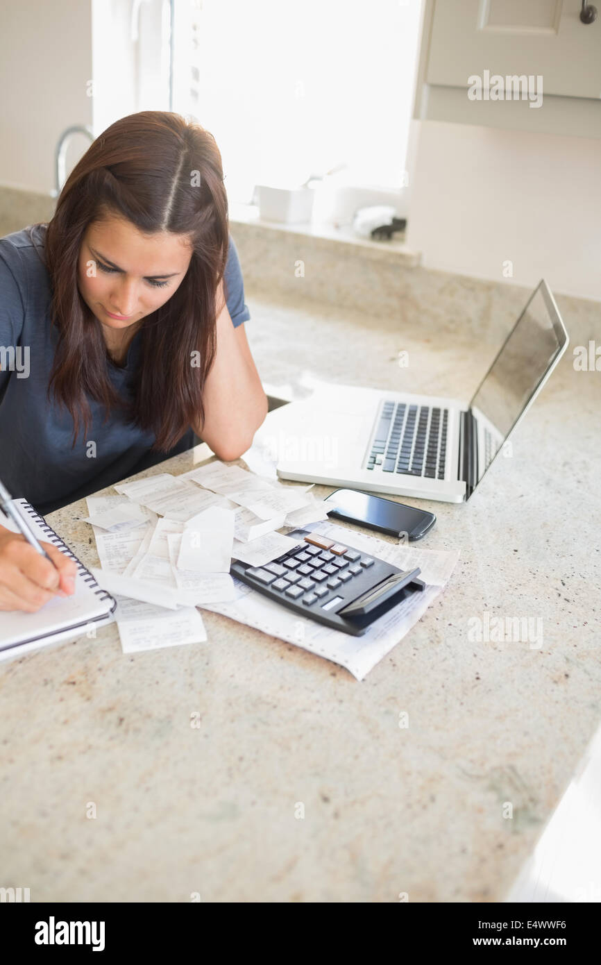 Woman calculating finances Stock Photo - Alamy