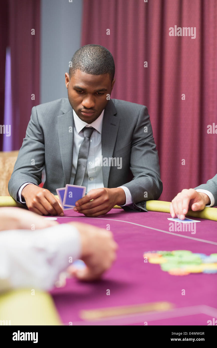 Man looking at his cards Stock Photo - Alamy