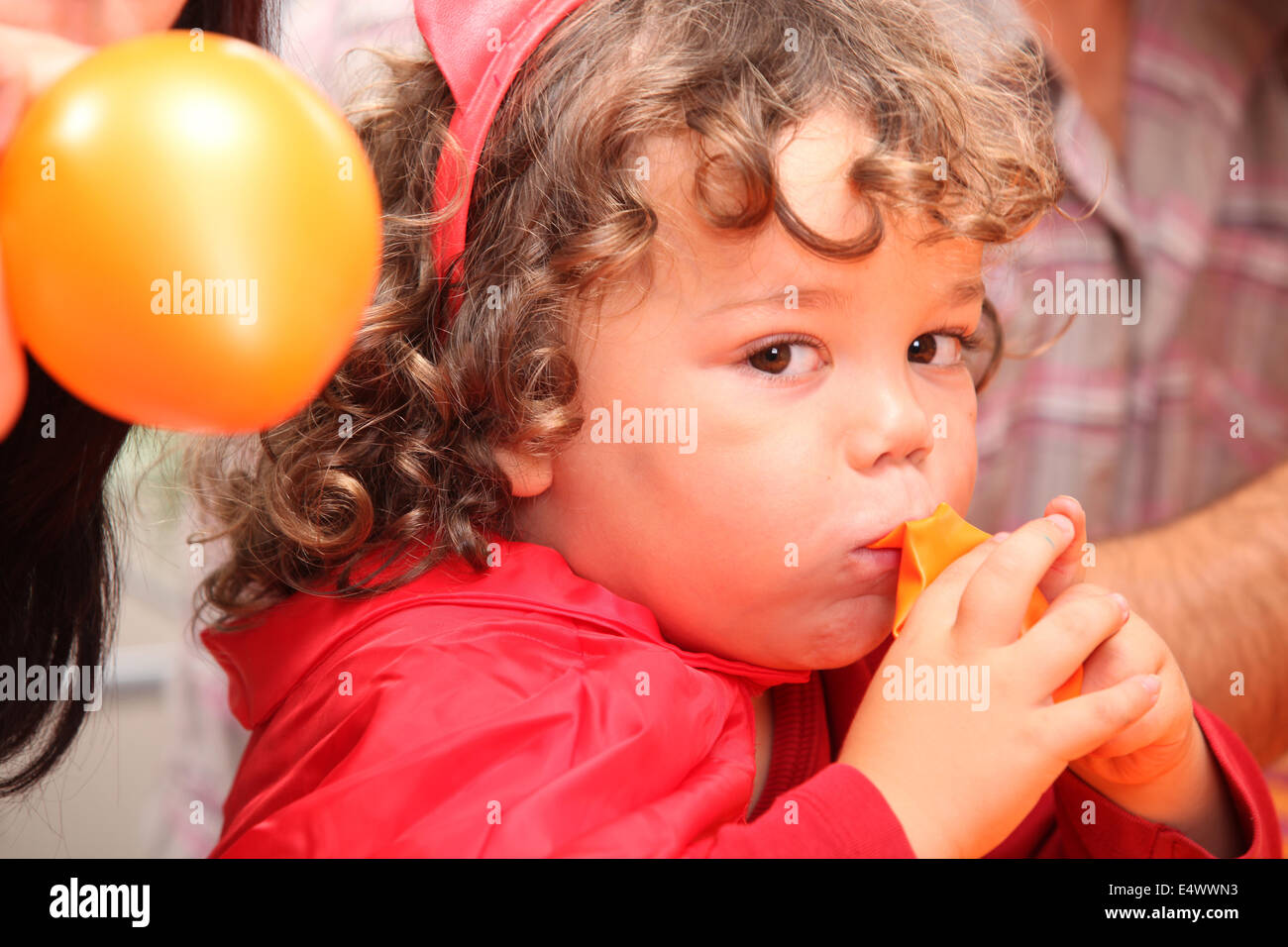 Child inflating balloon Stock Photo - Alamy