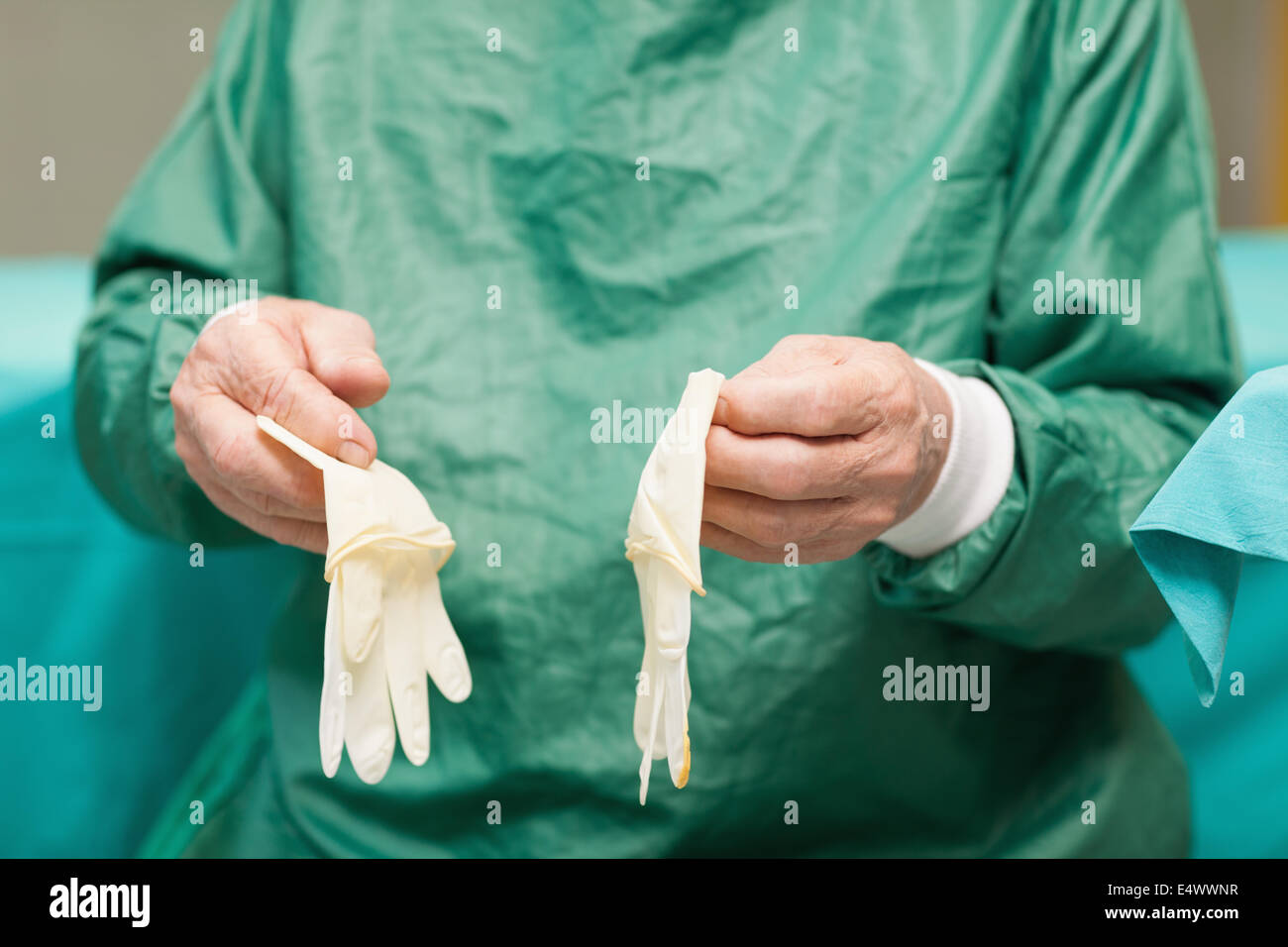 Surgeon holding surgical gloves Stock Photo - Alamy