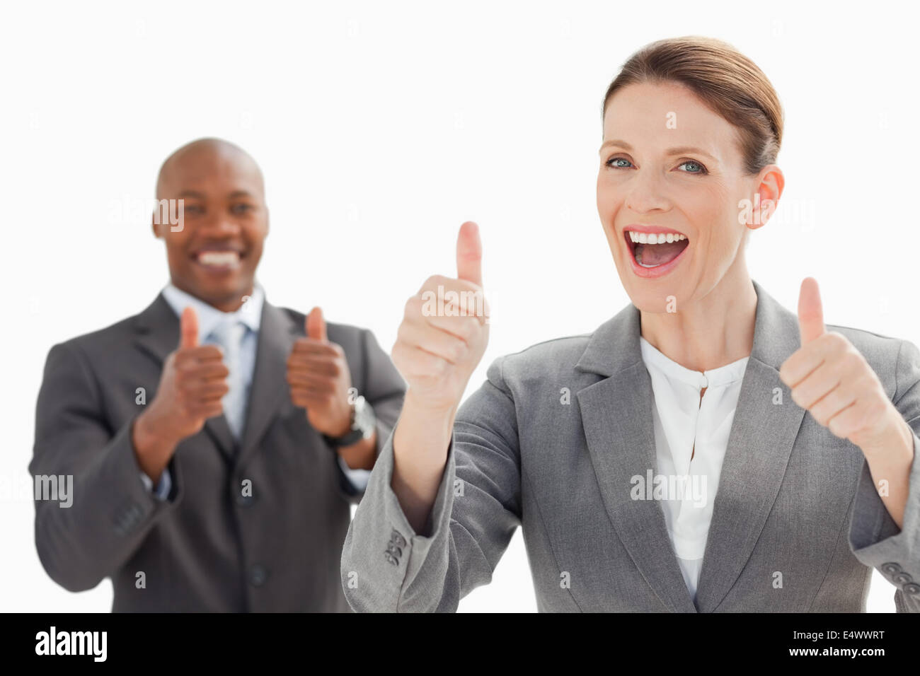 Excited businesspeople with thumbs up Stock Photo - Alamy