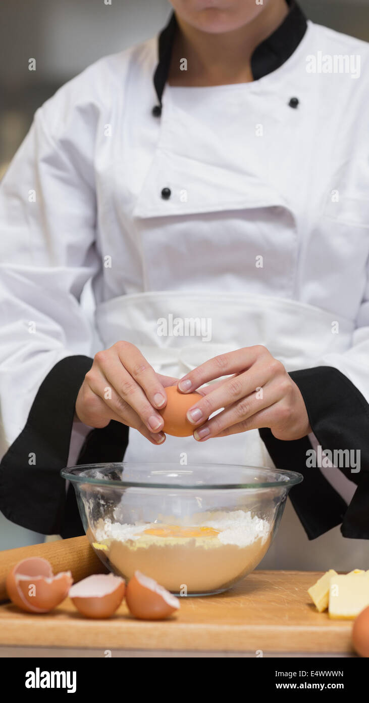 Woman cracking egg flour hi-res stock photography and images - Alamy