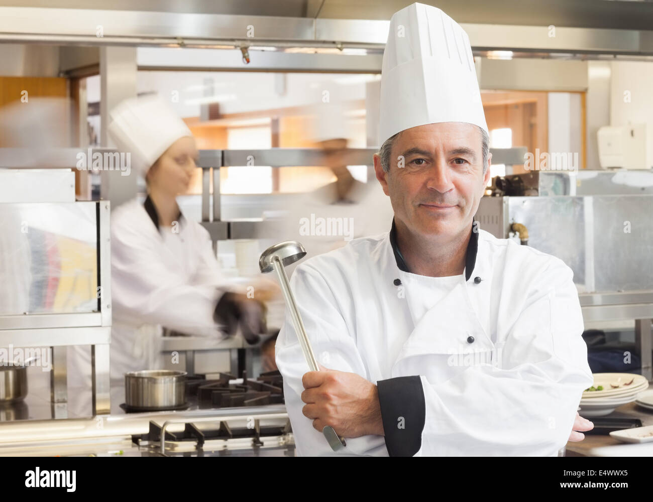 Chef holding ladle smiling hi-res stock photography and images - Alamy