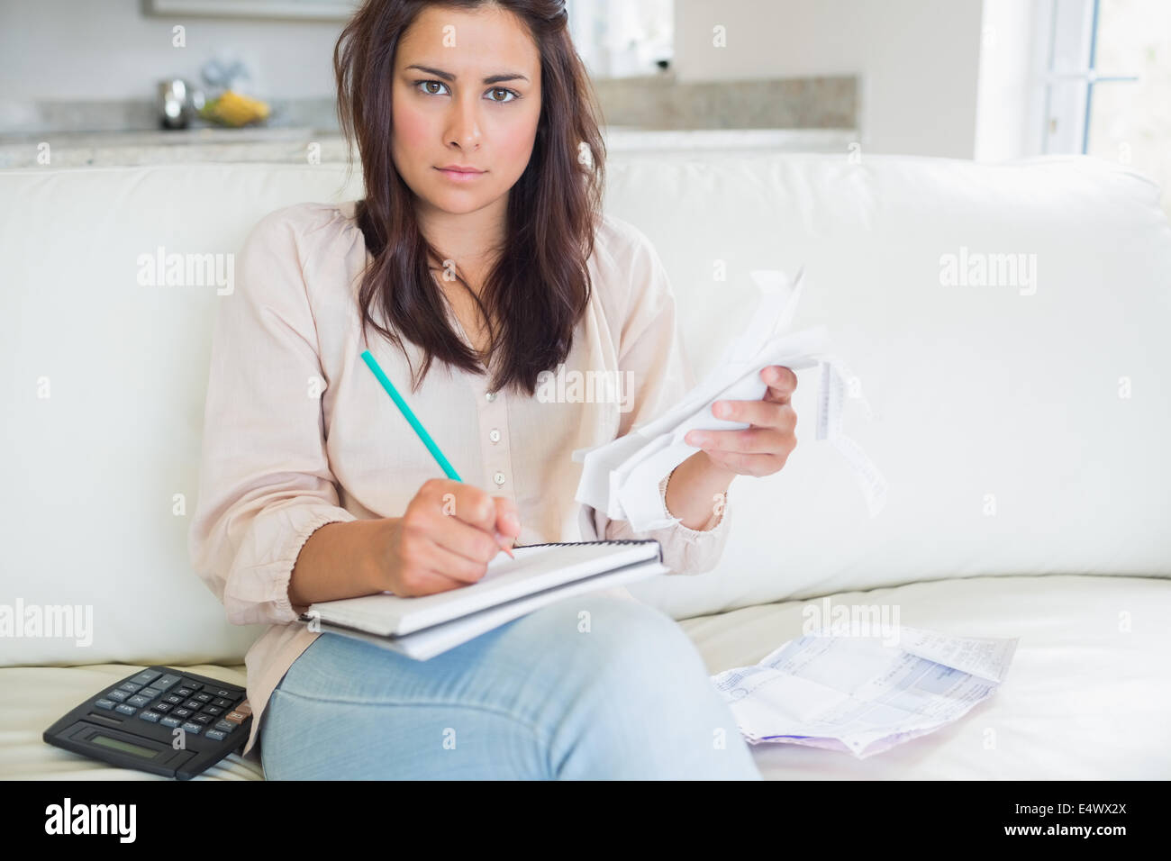 Young woman looking stressed over bills Stock Photo - Alamy