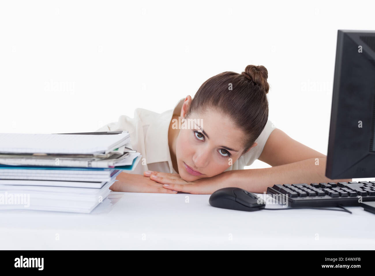 Sad secretary leaning on her desk Stock Photo - Alamy