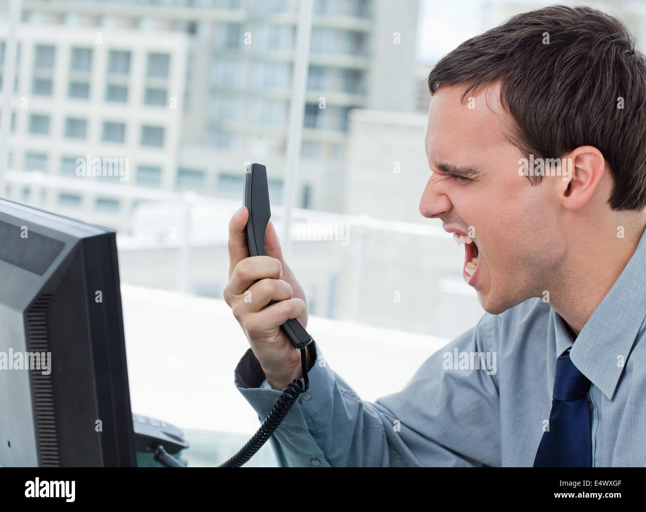 Angry office worker on the phone Stock Photo - Alamy