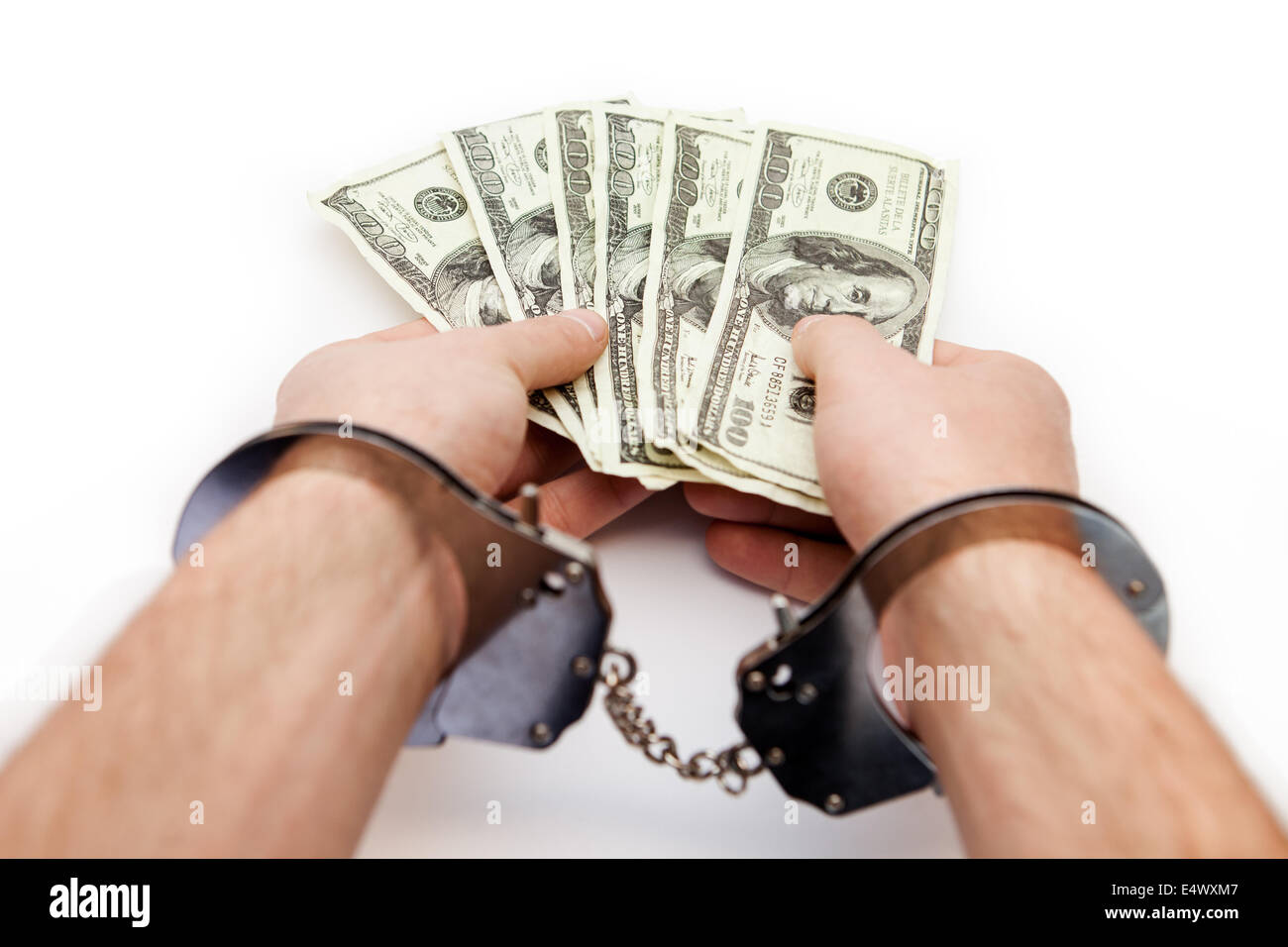 Shackled hands holding dollars Stock Photo - Alamy