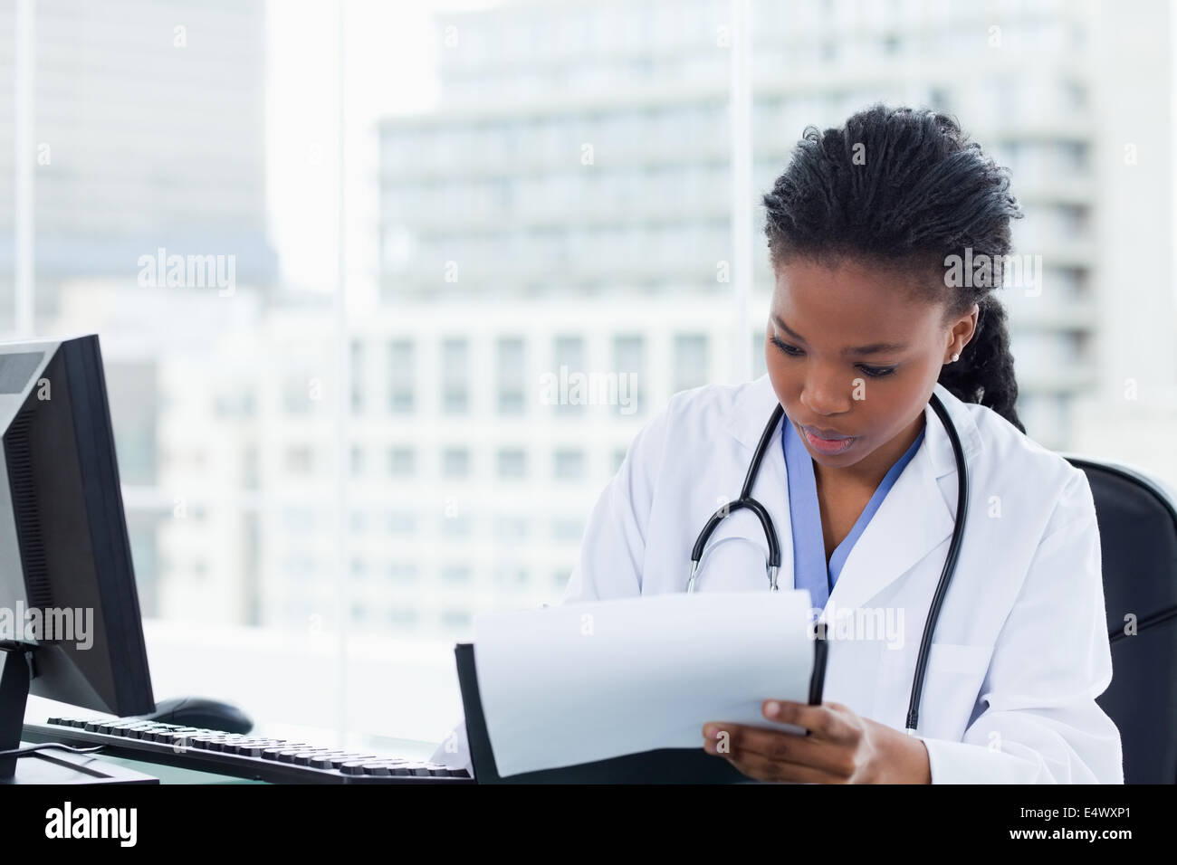 Woman doctor signing medical document hi-res stock photography and ...