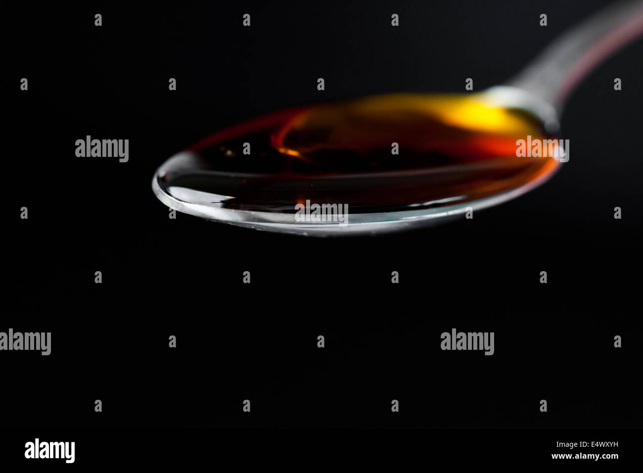 Full honey spoon Stock Photo - Alamy