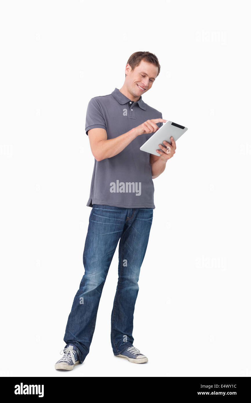 Smiling young man using tablet computer Stock Photo - Alamy