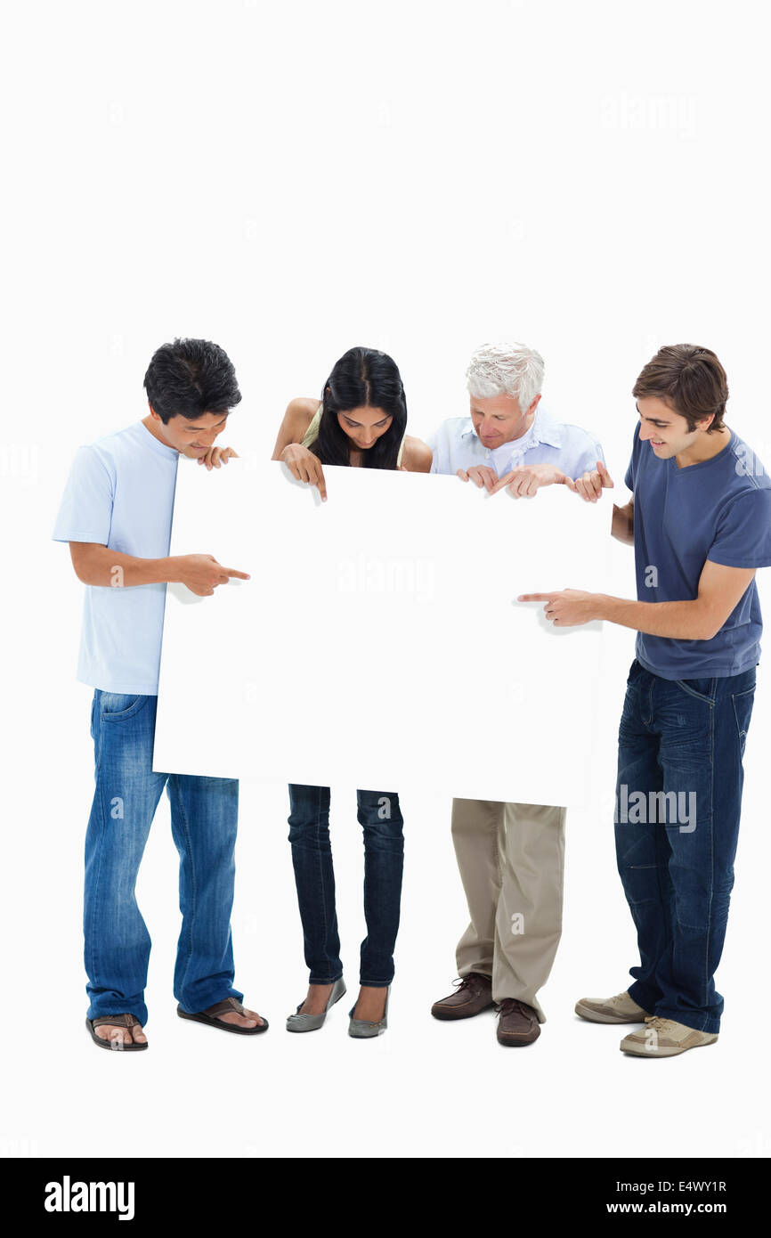 People holding and watching a big sign Stock Photo - Alamy