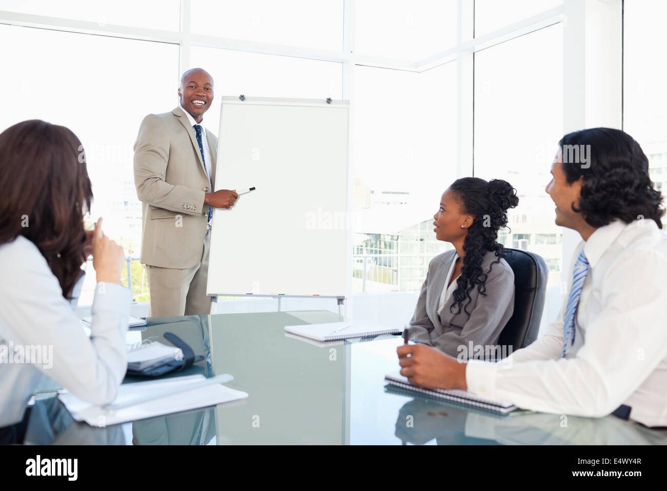 Smiling young executive giving a presentation Stock Photo - Alamy