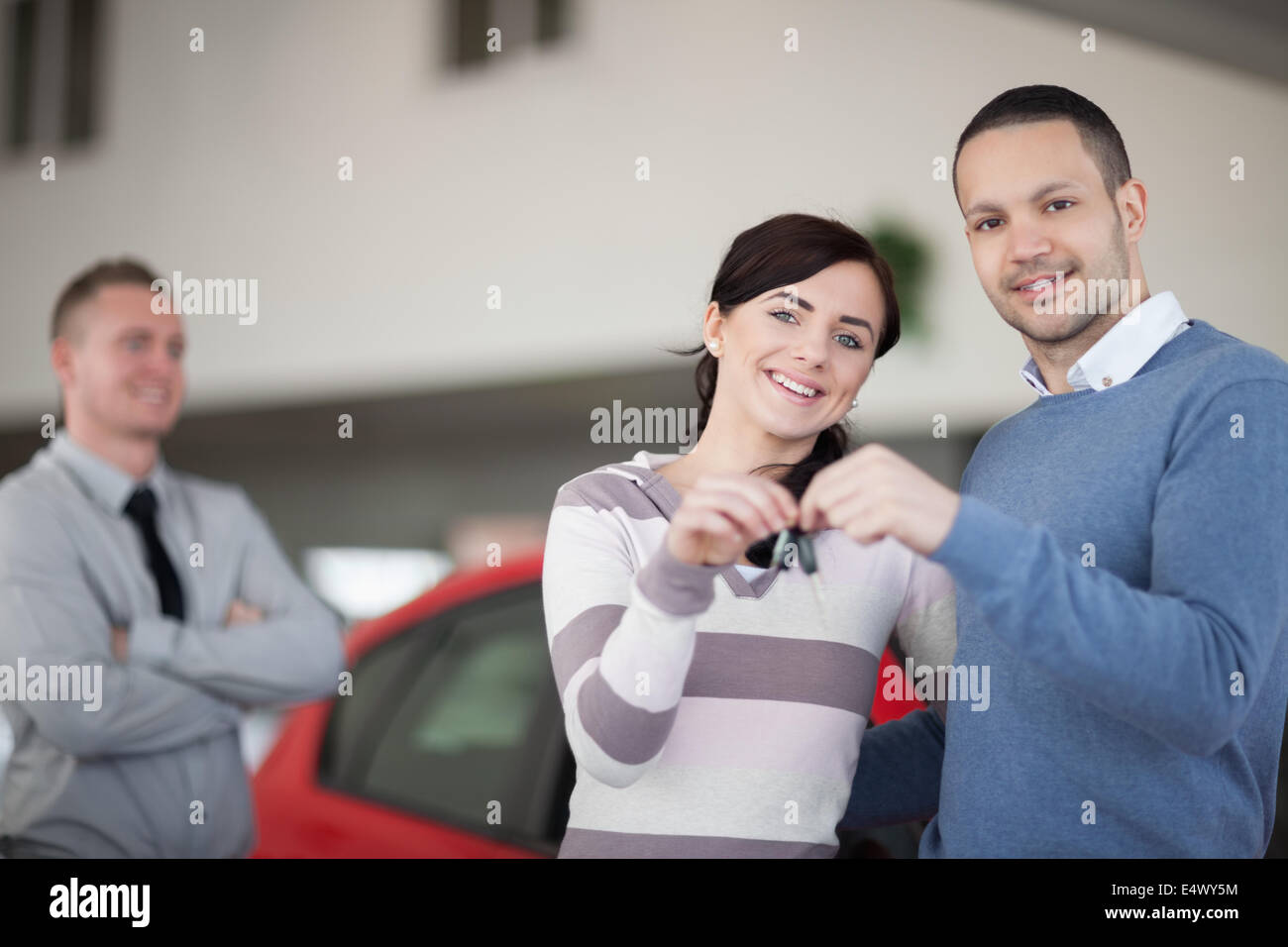 Happy couple holding keys together Stock Photo - Alamy