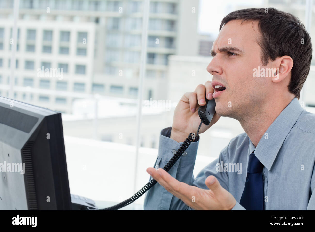 Confused office worker on the phone Stock Photo - Alamy