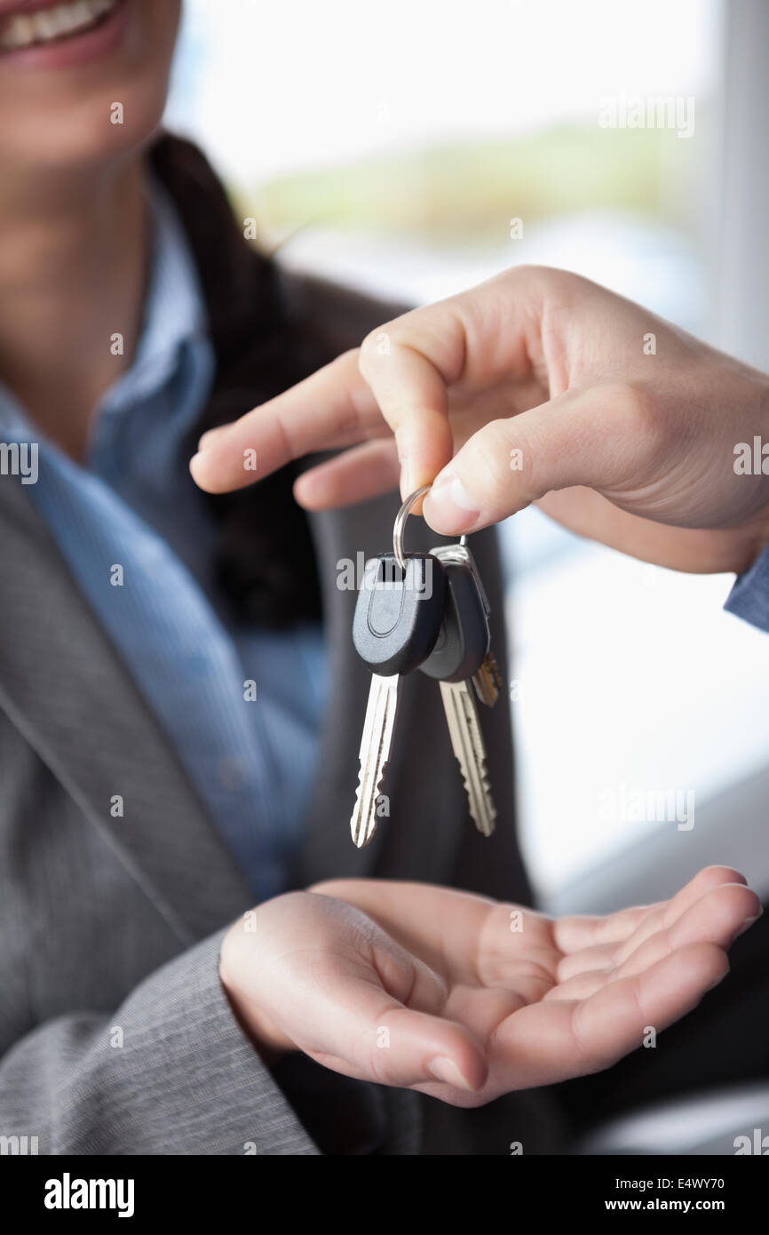 Woman smiling while receiving keys Stock Photo - Alamy