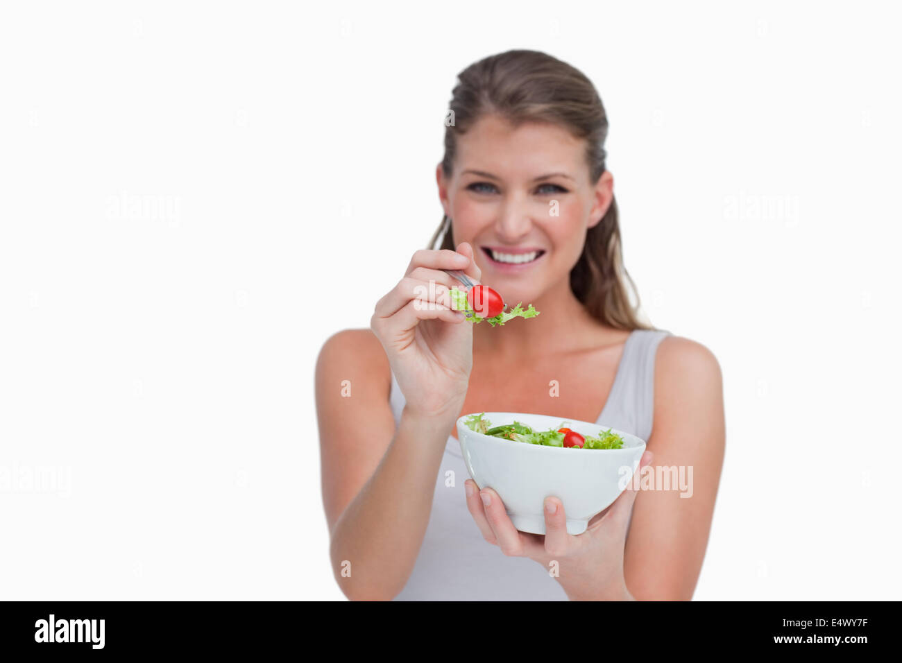 Smiling woman eating a salad Stock Photo - Alamy