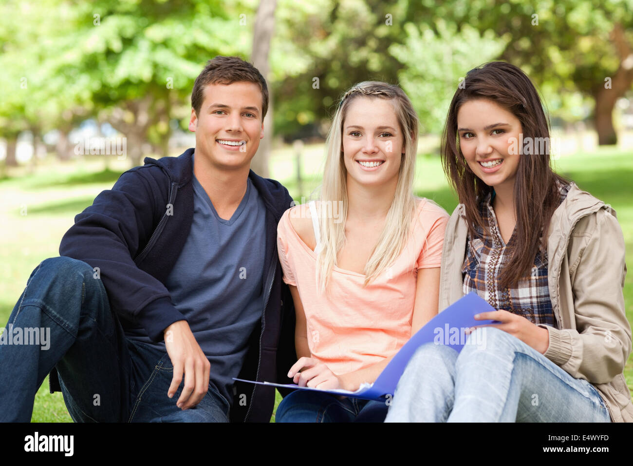Portrait of three teenagers studying together Stock Photo - Alamy