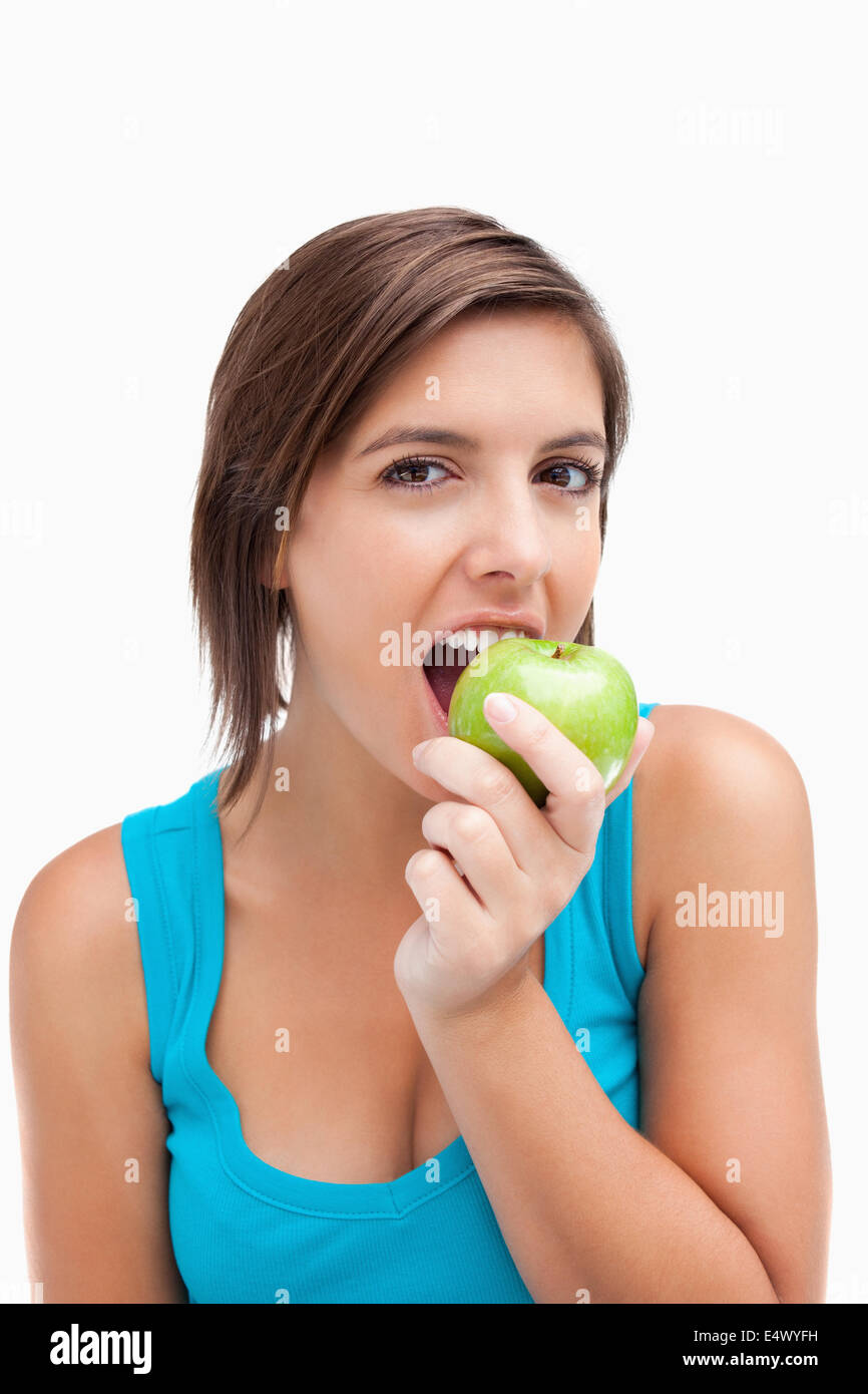 Attractive teenager eating a green apple Stock Photo - Alamy