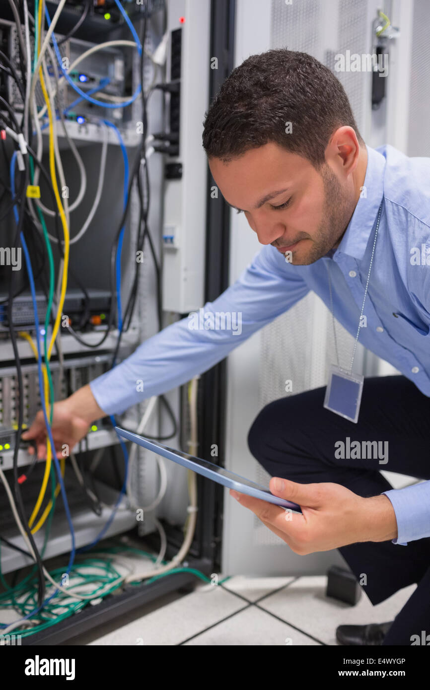 Man using tablet pc to work on servers Stock Photo - Alamy
