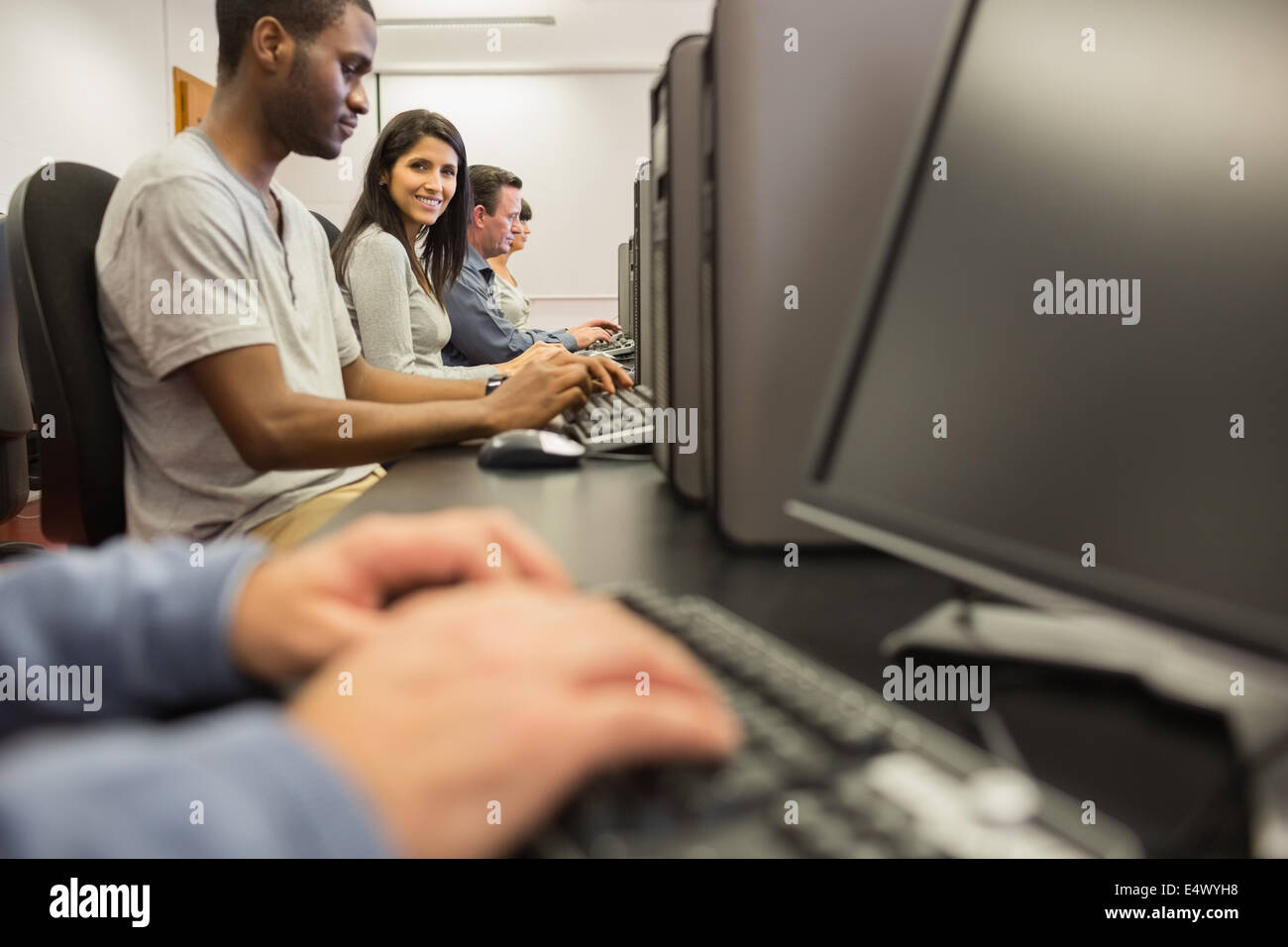 Woman looking up from computer class Stock Photo - Alamy