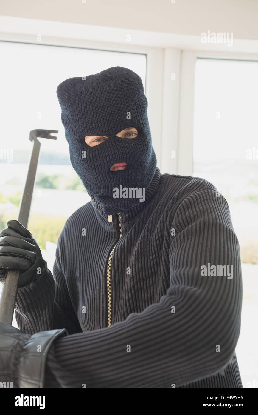 Robber holding a crowbar Stock Photo - Alamy