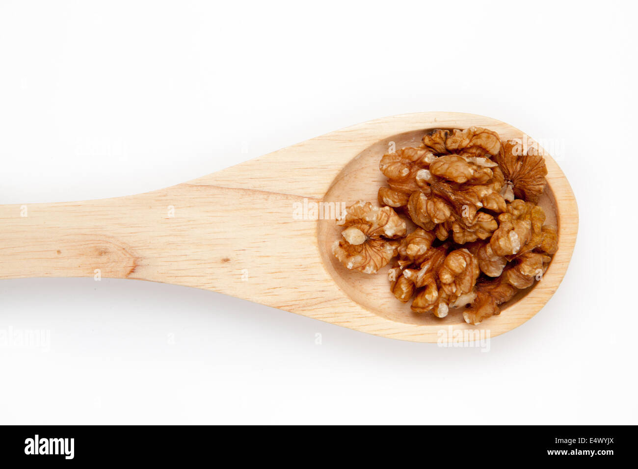 Wooden spoon with nuts Stock Photo - Alamy