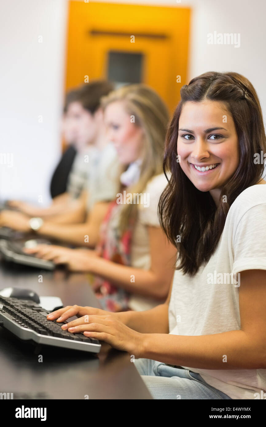 Student sitting at the computer smiling Stock Photo - Alamy