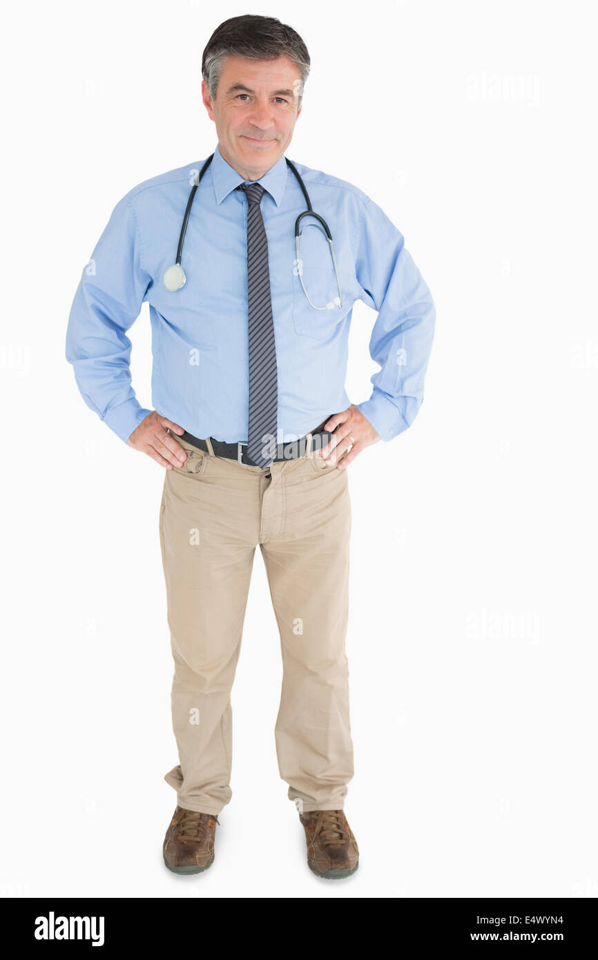 Doctor standing and smiling Stock Photo - Alamy