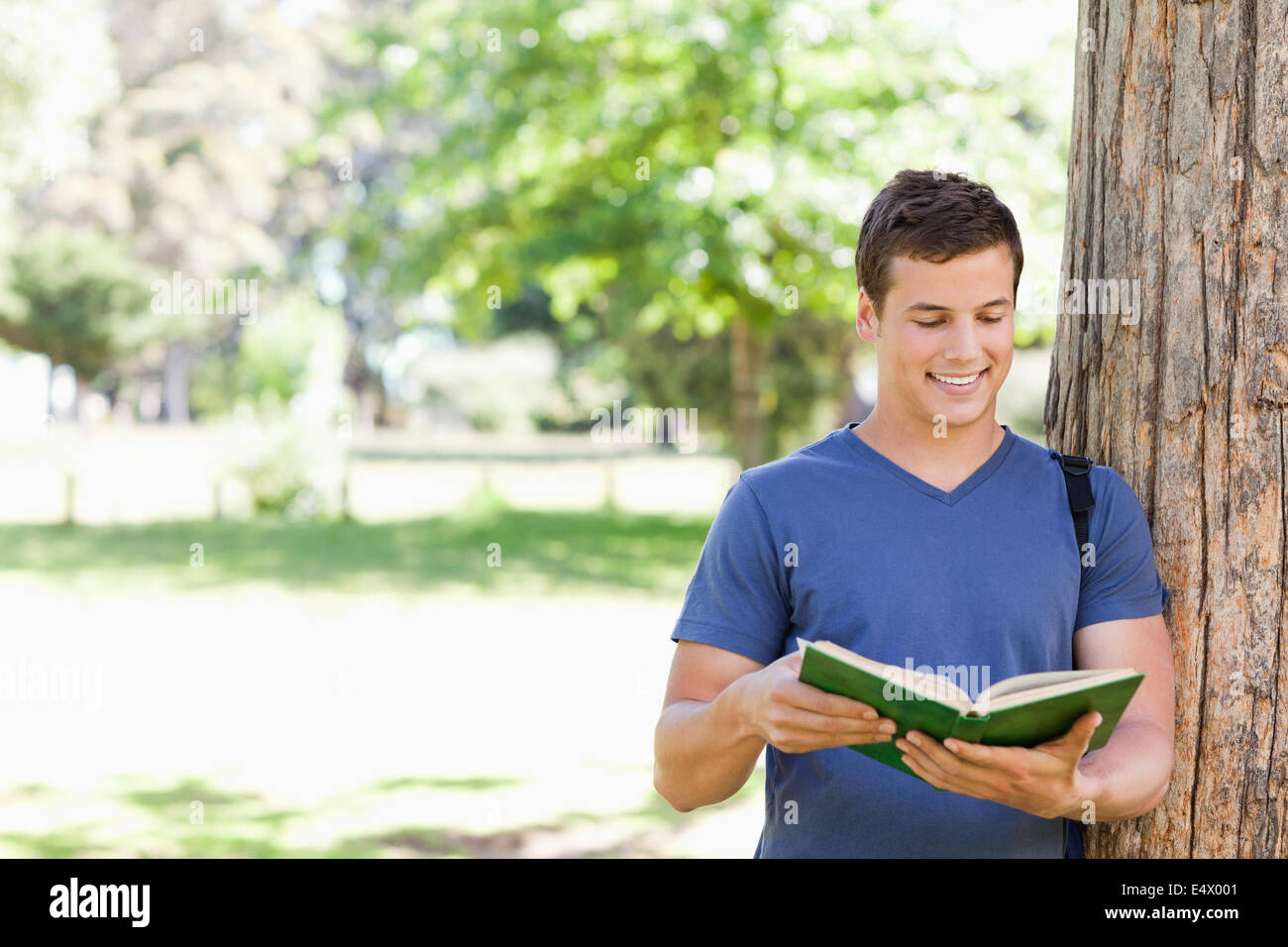 Muscled student holding a textbook Stock Photo - Alamy