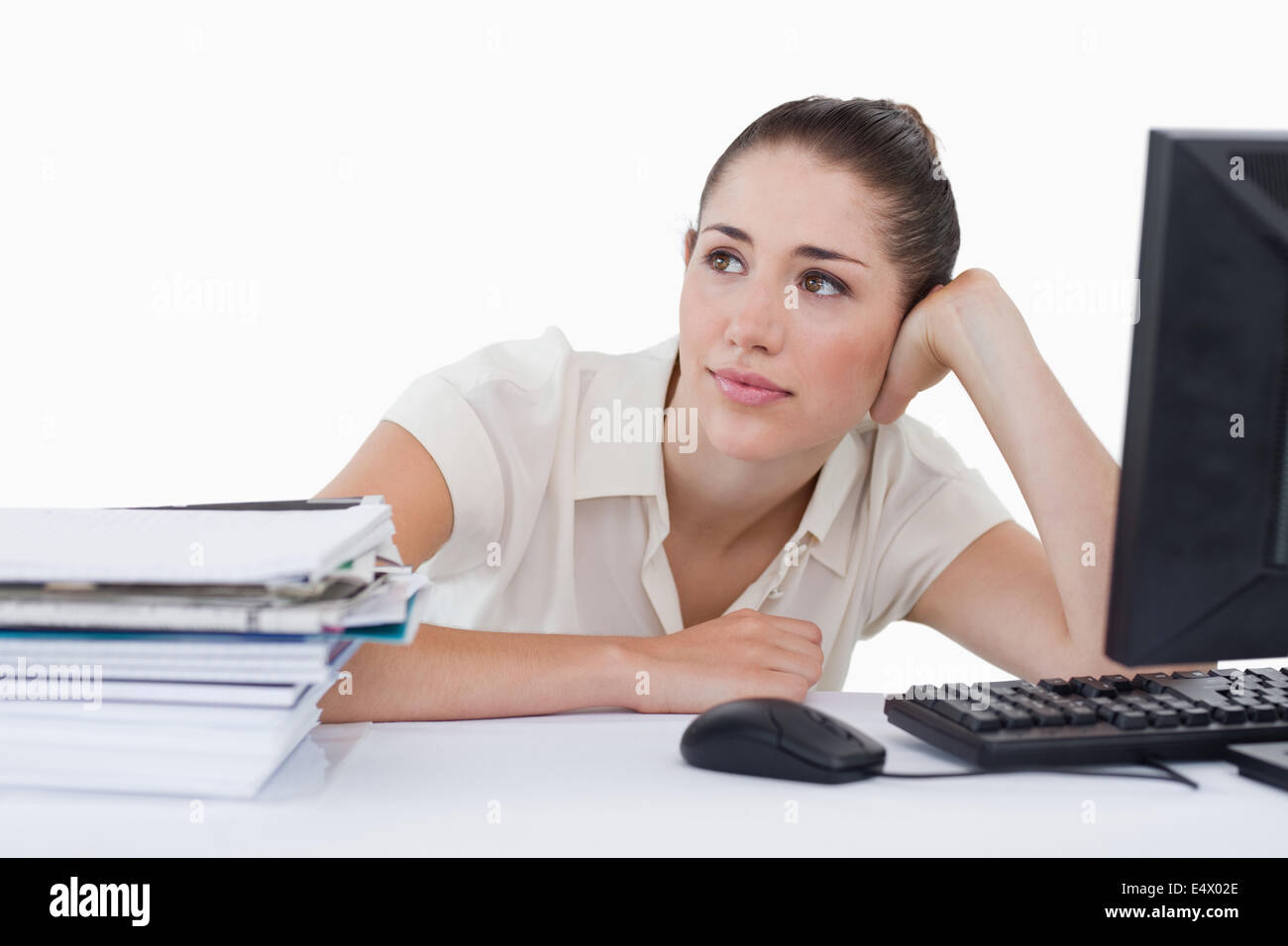 Dreaming businesswoman leaning on her desk Stock Photo - Alamy