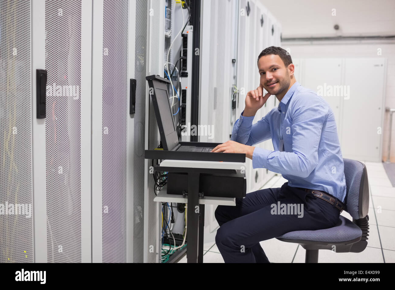 Man looking up from working with servers Stock Photo - Alamy