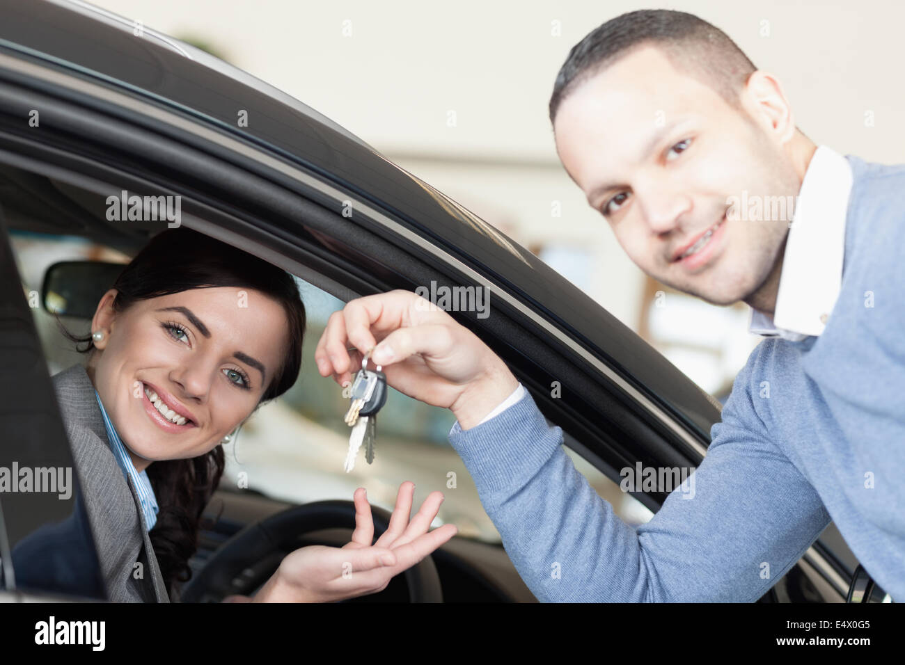 Man giving car keys to a woman Stock Photo - Alamy